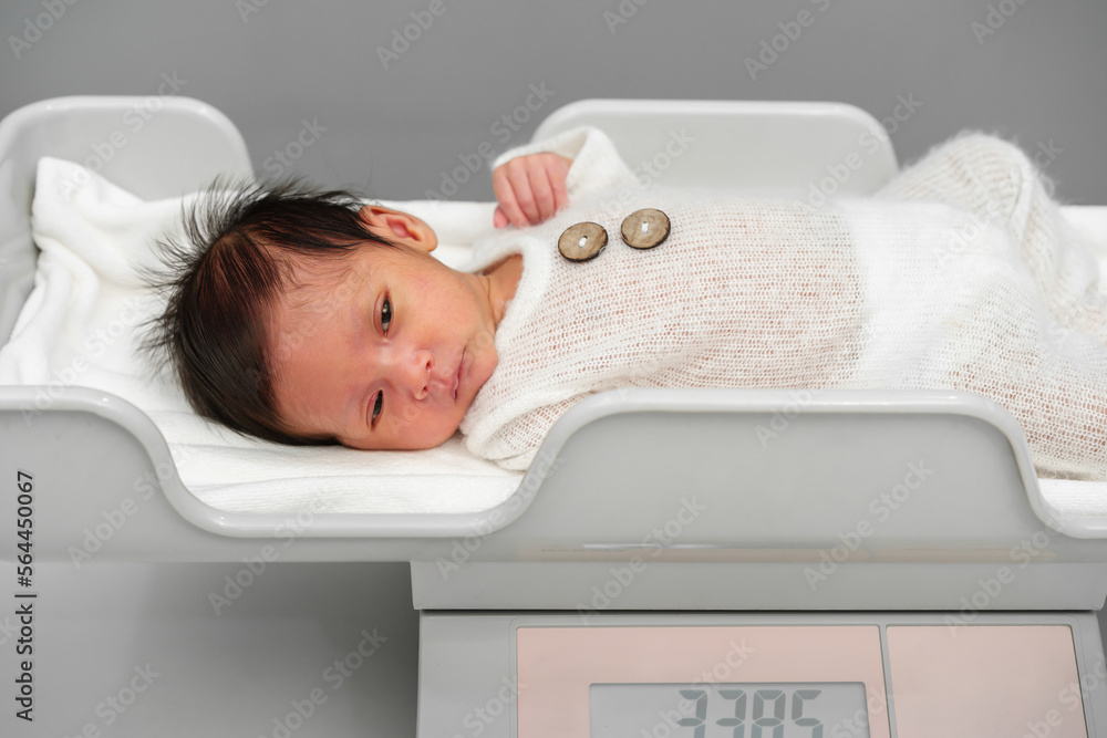 newborn baby weight measurement on digital scales Stock Photo | Adobe Stock