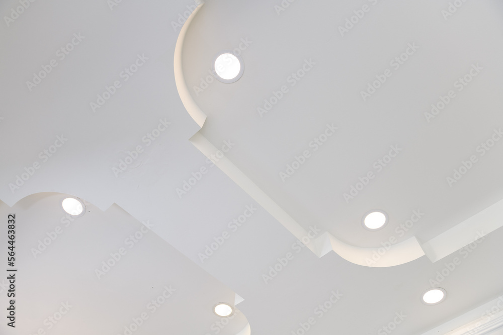 Stretch ceiling white and complex shape. ceiling with halogen spots ...