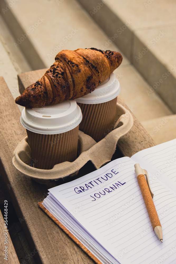 Writing Gratitude Journal on wooden bench. Coffee and croissants ...