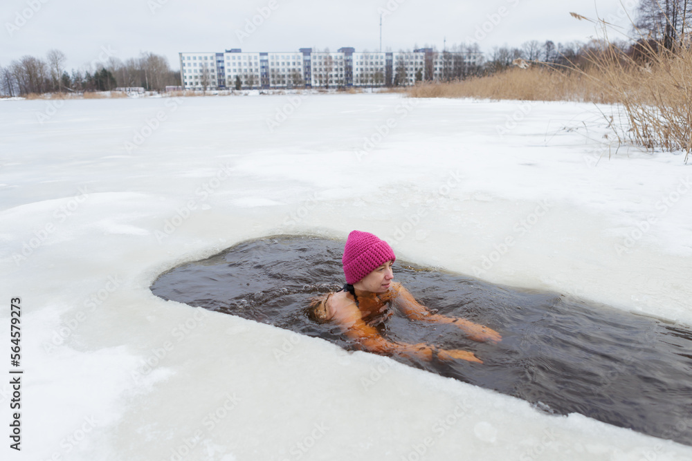 Winter swimming. Woman in frozen lake ice hole. Swimmers wellness and ...