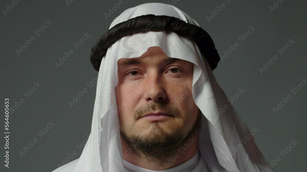 Portrait close up of successful arab man in traditional outfit, wearing ...