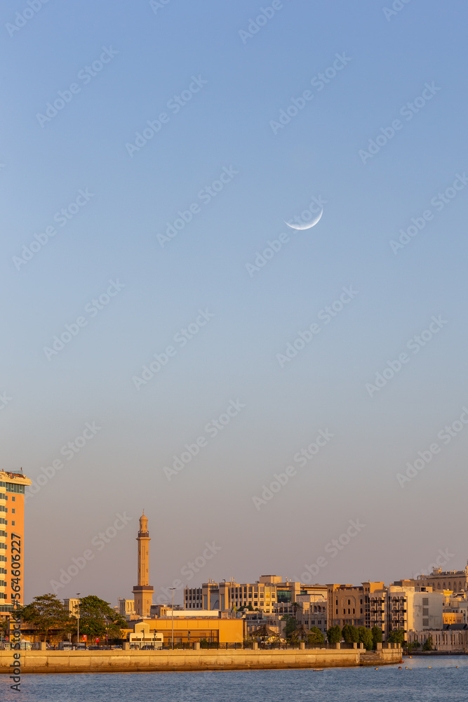Skyline of Deira, Dubai during sunset with Dubai Creek, mosque minaret ...