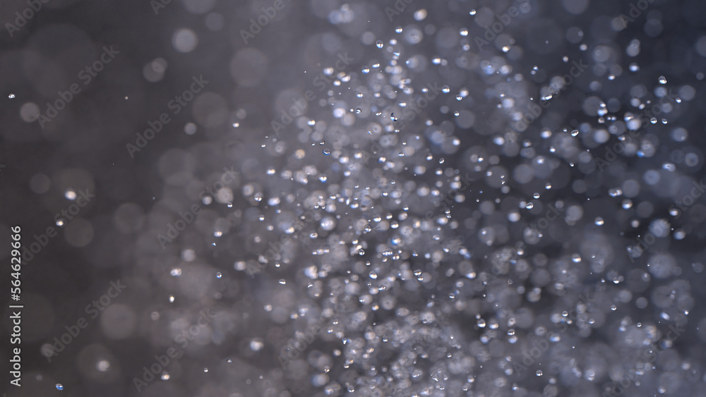 burst of transparent particles resembling water splash on black ...
