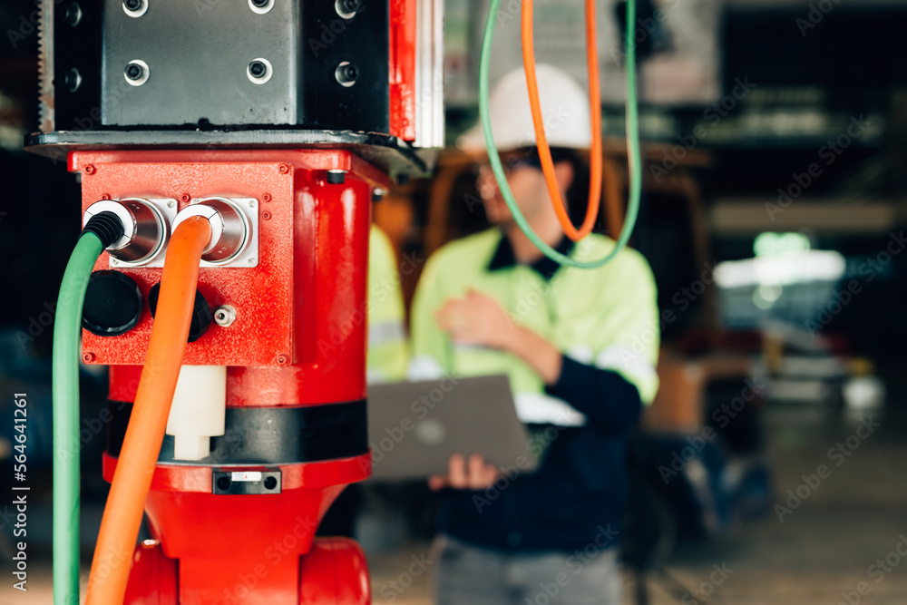 Technician engineer holding robot controller checking and repairing ...