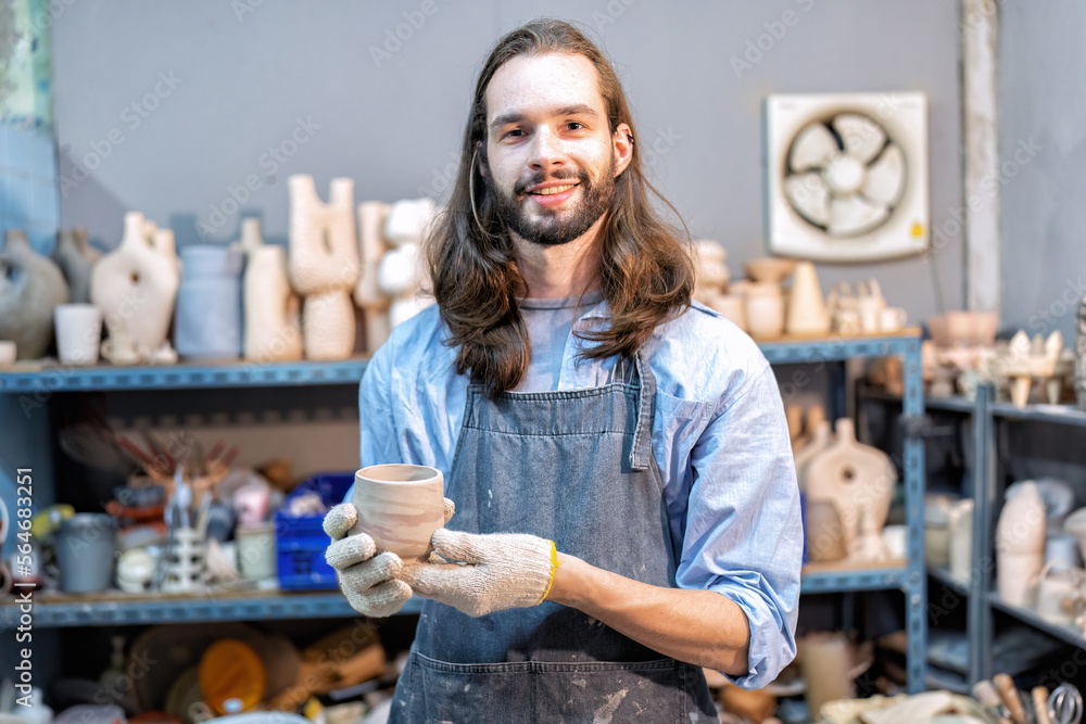 Pot making man arrange the ceramic clay pot on the shelf in pottery ...