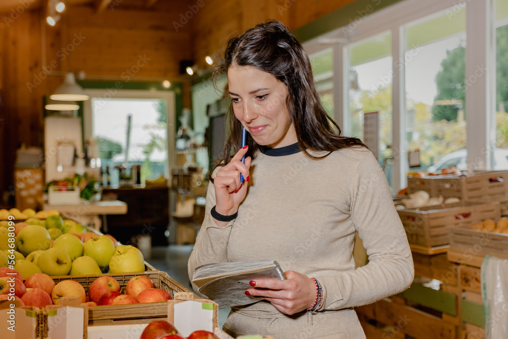 Store manager counts fruits and vegetables in wooden boxes of a grocery ...