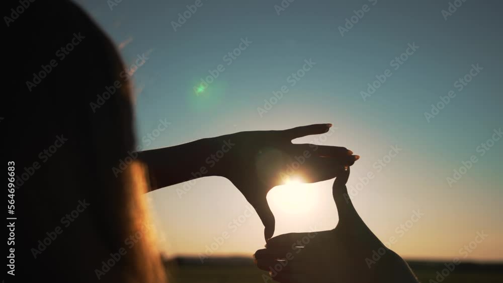 Business strategy. Girl folded her hands in frame at sunset. Silhouette ...