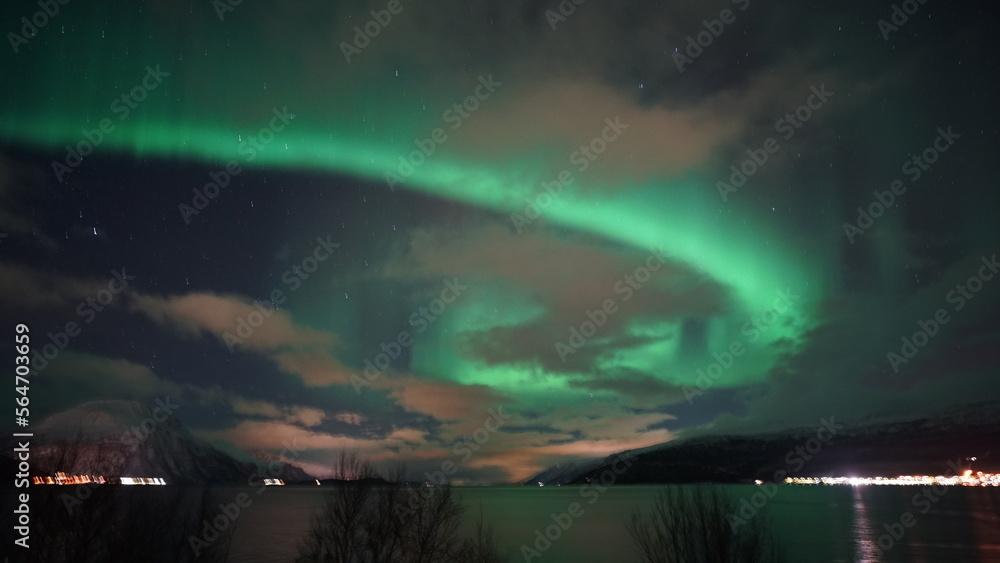 Northern lights (Aurora Borealis) with clouds reflecting light ...