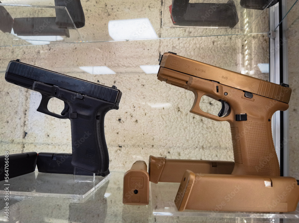 Pistols glock 19x and glock 17 gen 5 on a gun store window. Baltic ...