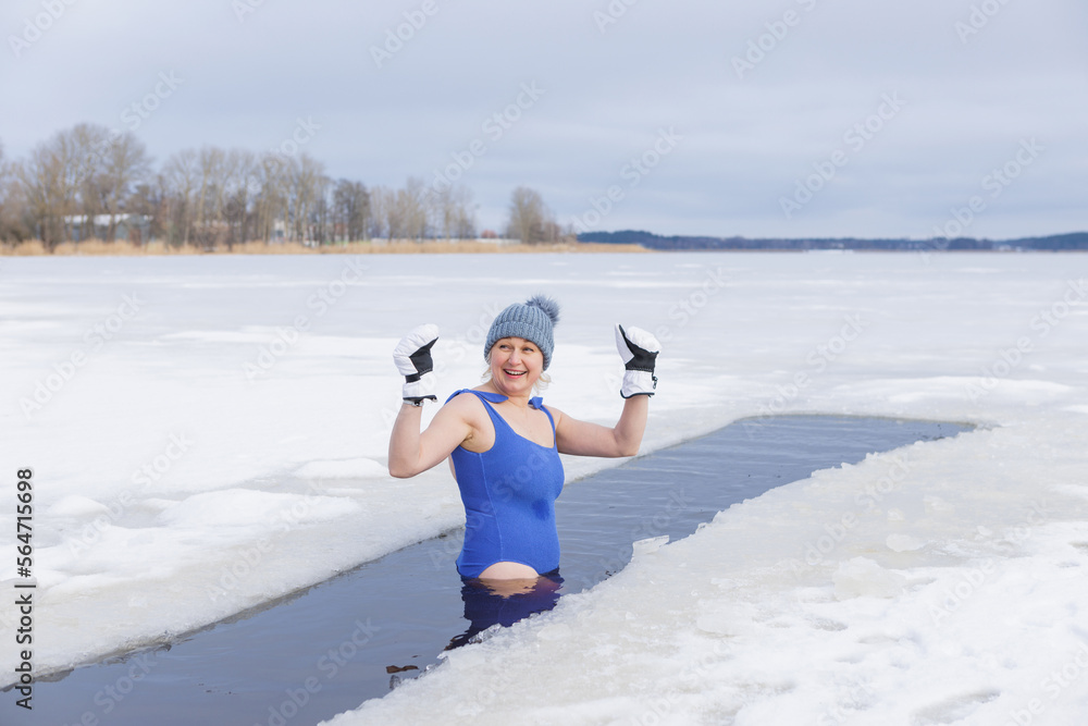 Winter swimming. Woman in frozen lake ice hole. Swimmers wellness and ...