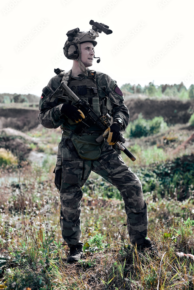caucasian european army soldier outdoors, standing with assault rifle ...