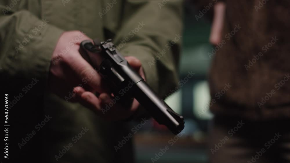 Hunter holding and loading Revolver before shooting it at an shooting ...