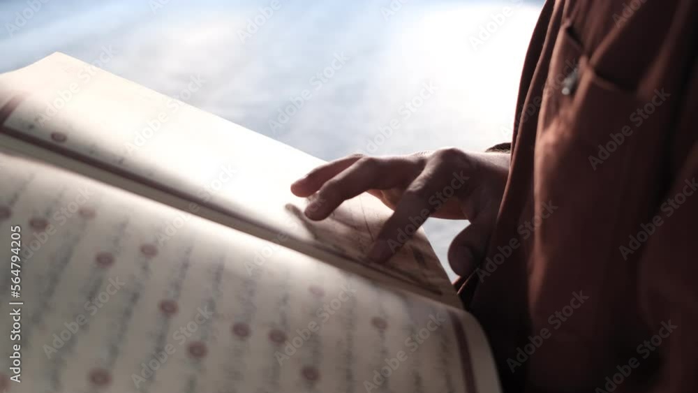 Open Quran with Arabic writing visible, religious book with Arabic ...