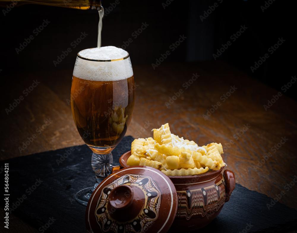 Serving beer in a stem glass alongside a Bulgarian appetizer of French ...