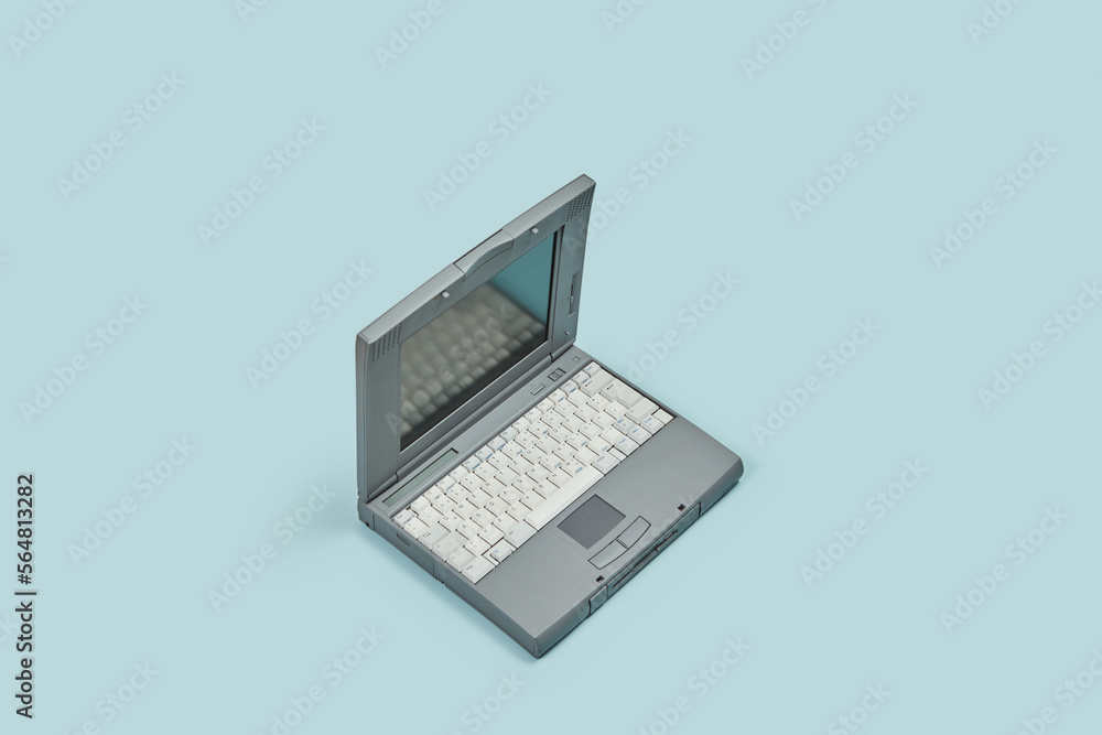 Retro 90s laptop on blue background. Stock Photo | Adobe Stock