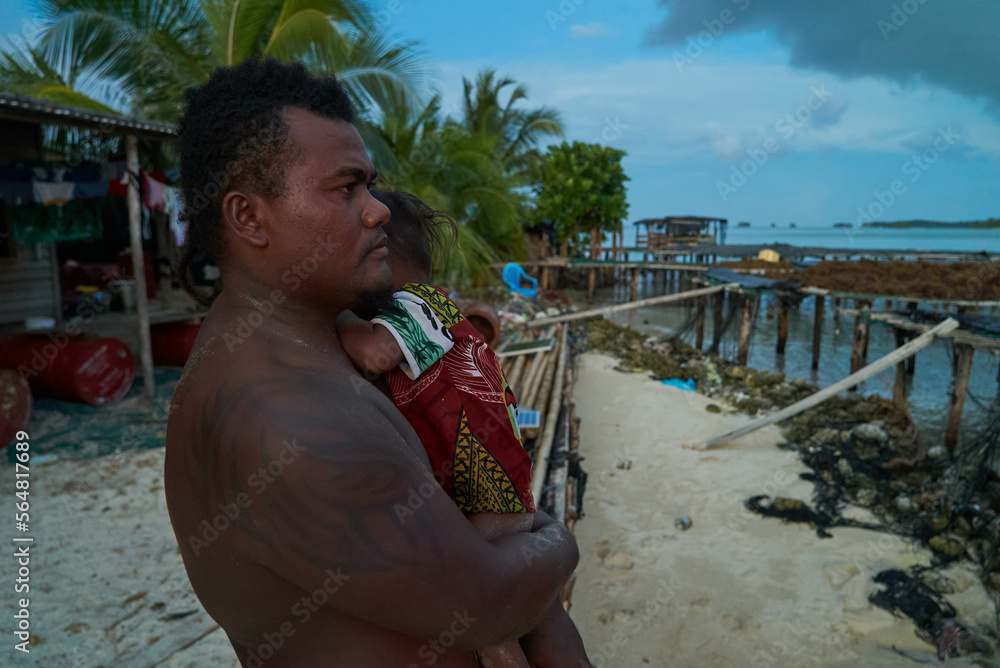 Solomon Islander man & baby faces intergenerational sea level rise ...