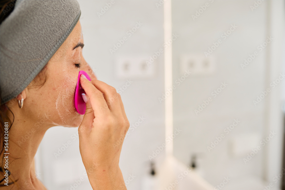 Washing face with cleanser woman. Stock Photo | Adobe Stock