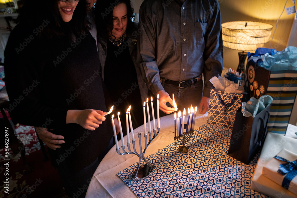Hanukkah: Family Gathers To Light Two Menorahs Stock Photo | Adobe Stock
