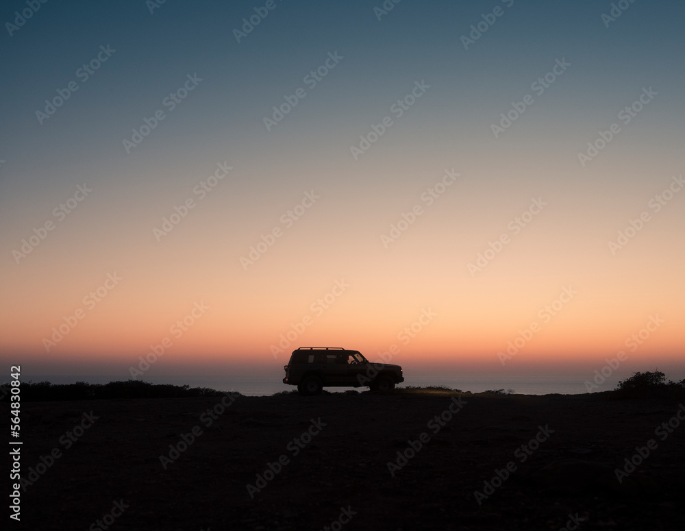 4x4 car silhouette driving on wild coast scenery at sunset Stock Photo ...