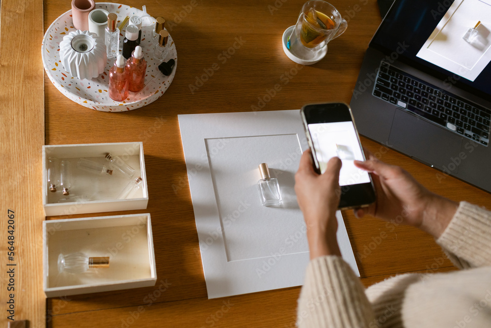 Anonymous designer taking a photo of perfume Stock Photo | Adobe Stock