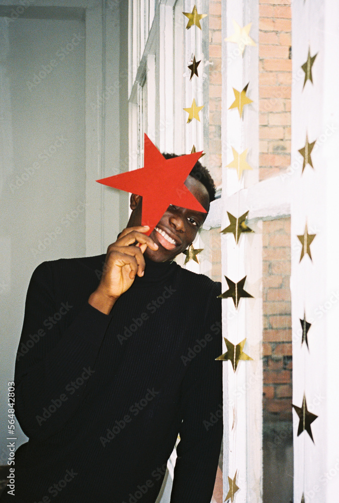 User-generated content happy man with red star near window Stock Photo ...