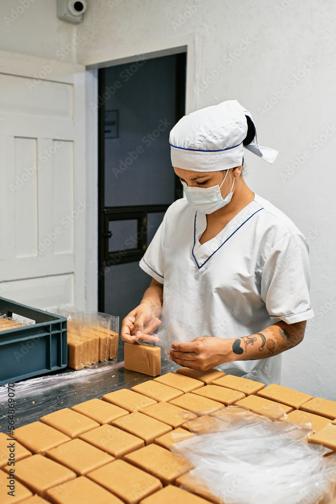 Operator packaging dulce de leche cheese Stock Photo | Adobe Stock