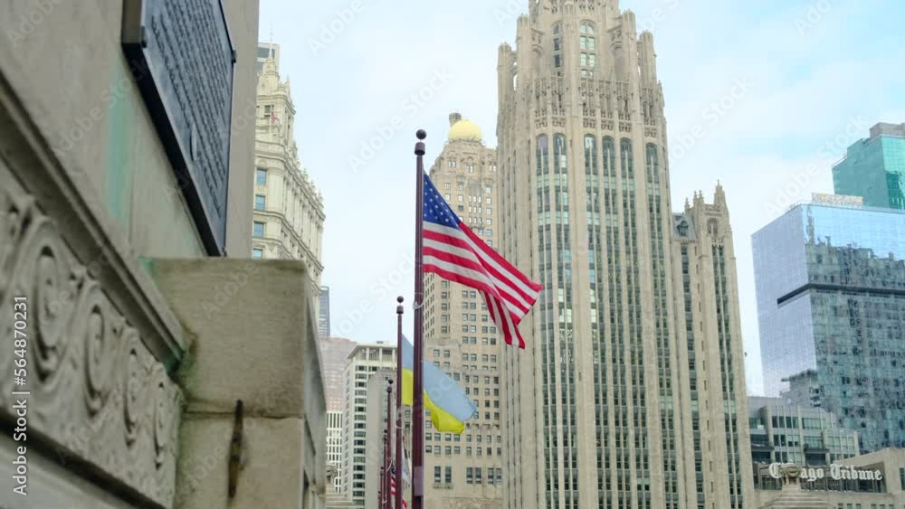 Ukrainian national official flag and usa flag on flagpole waving in the ...