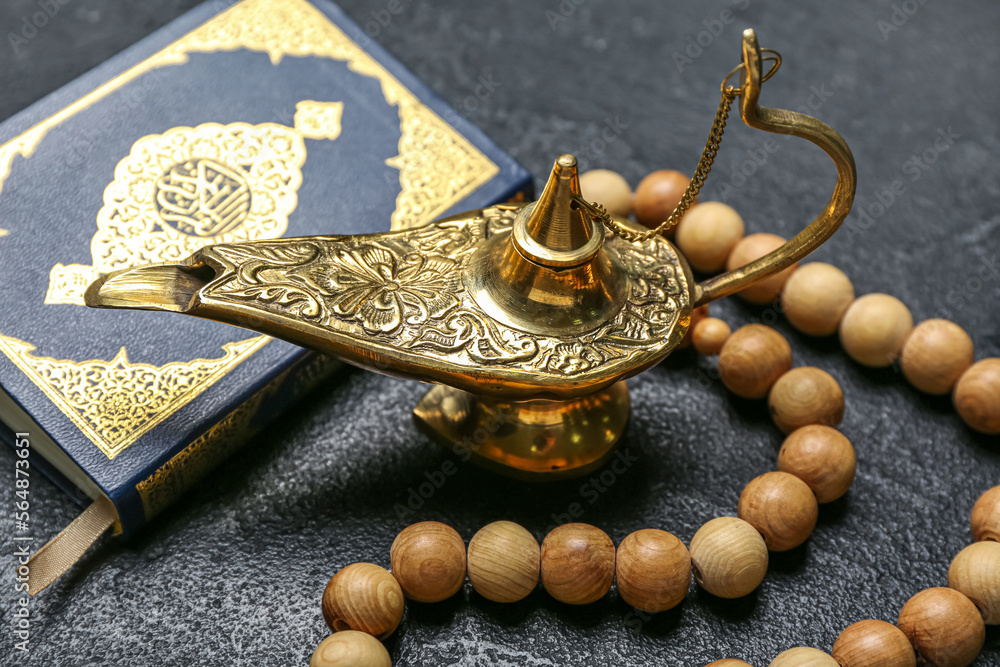 Aladdin lamp of wishes, Koran and prayer beads for Ramadan on dark ...