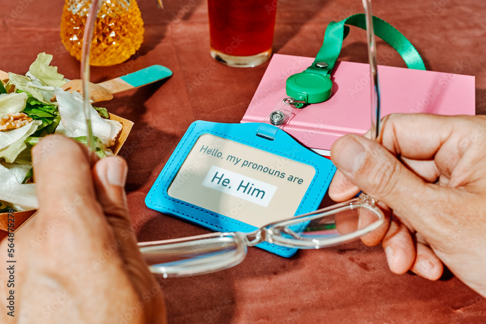 person next to a tag with the pronouns he, him Stock Photo | Adobe Stock