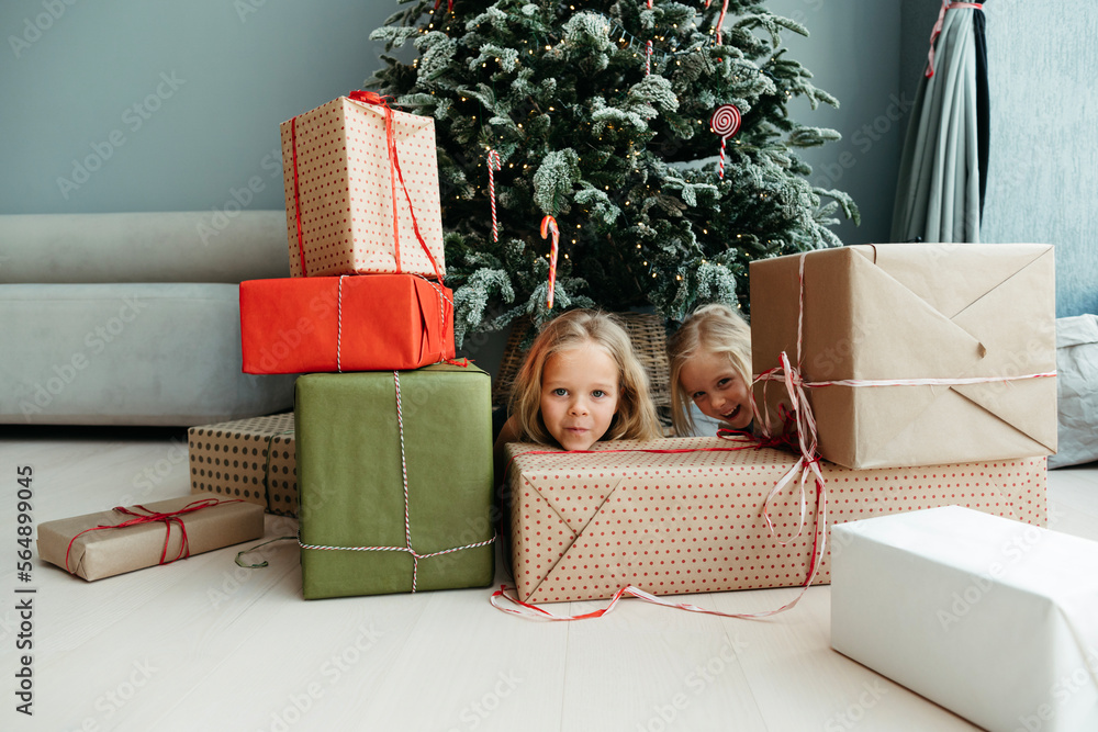 Happy kids opening presents. Stock Photo | Adobe Stock