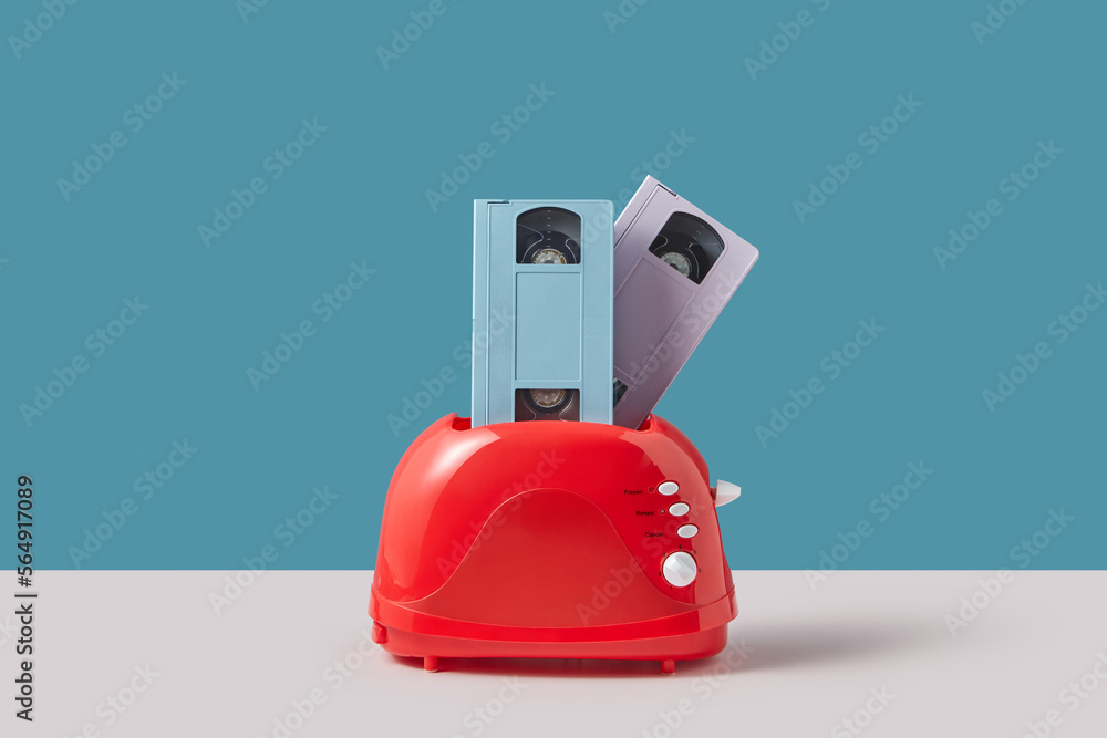 Red retro toaster with two VHS cassettes. Stock Photo | Adobe Stock
