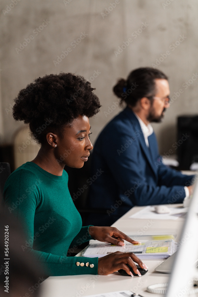 Black Woman Working At Her Desk And Using A Computer Mouse Stock Photo ...