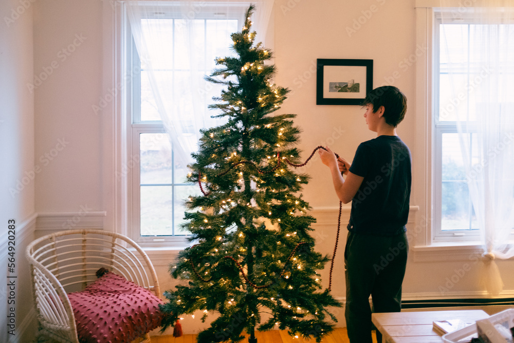 tween decorating a Christmas tree Stock Photo | Adobe Stock