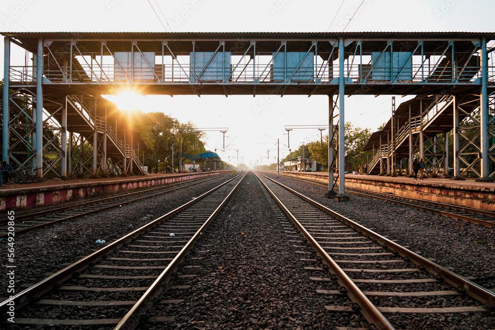 Low angle shot railway track with RAILWAY STEEL FOOT OVER BRIDGE ...