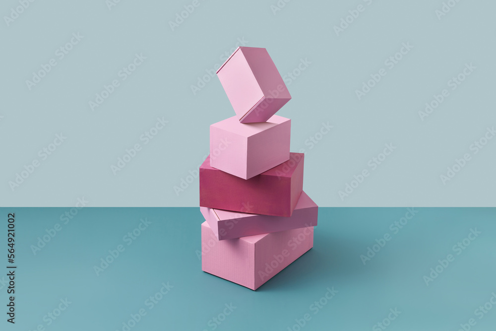 Pink cardboard boxes on blue background. Stock Photo | Adobe Stock