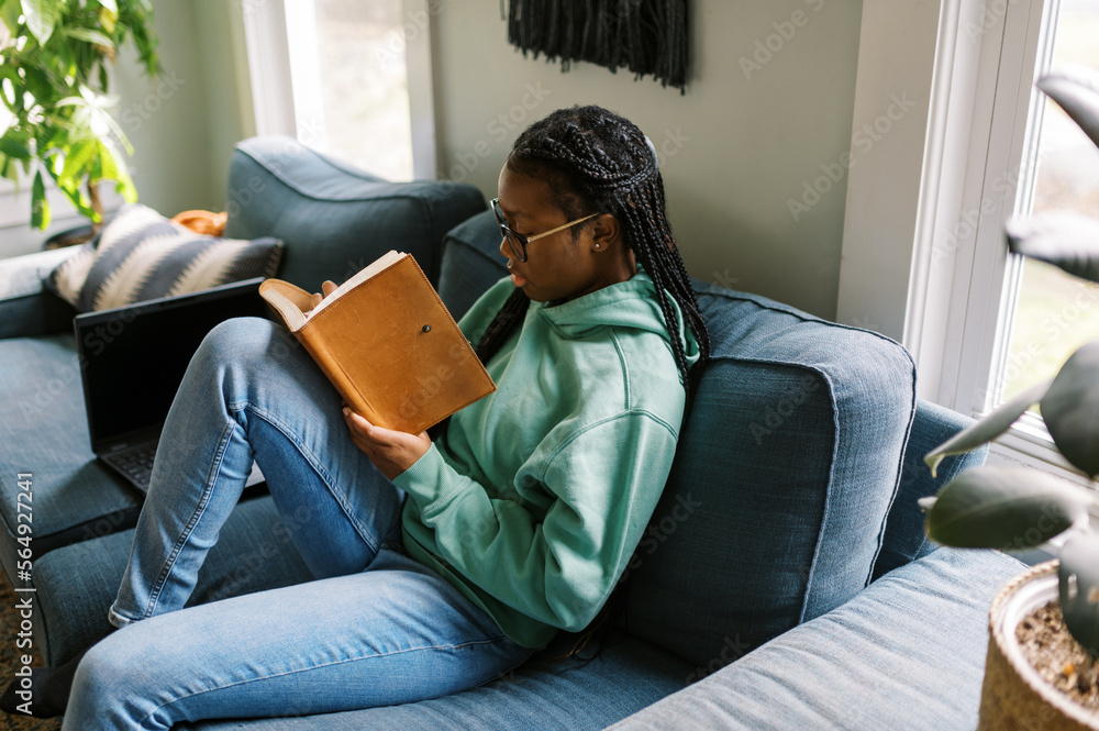 black teenage girl sitting down writing in a journal Stock Photo ...
