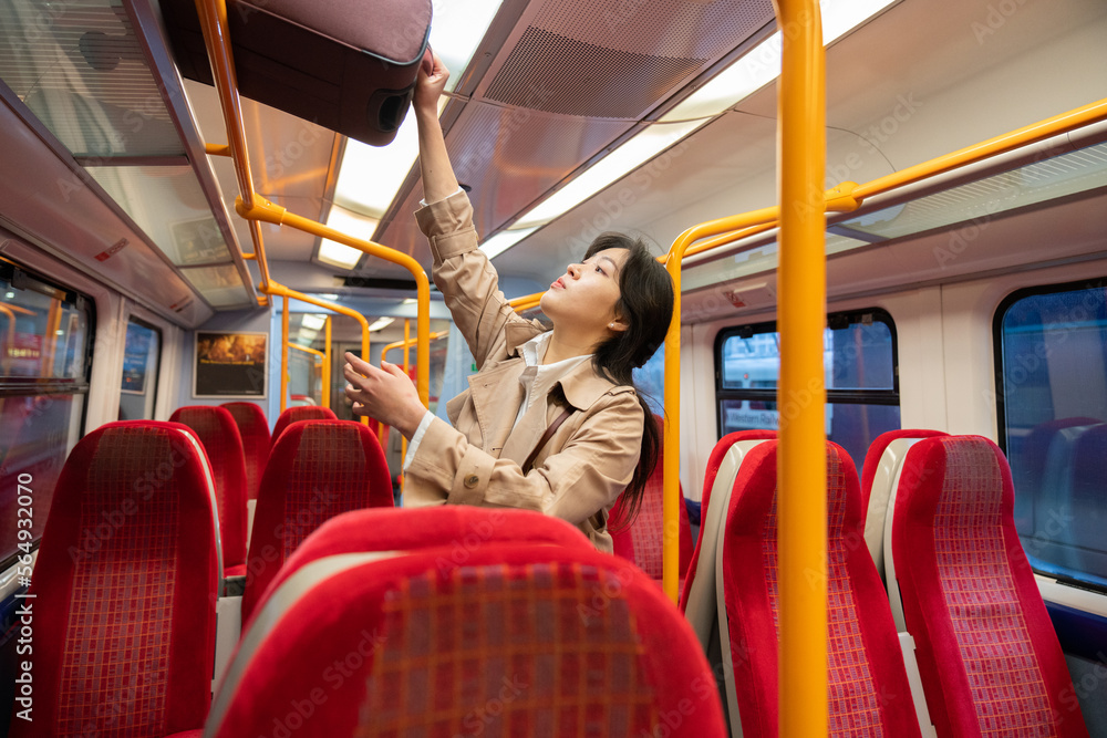 Passenger Putting Her Suitcase In The Train Stock Photo | Adobe Stock