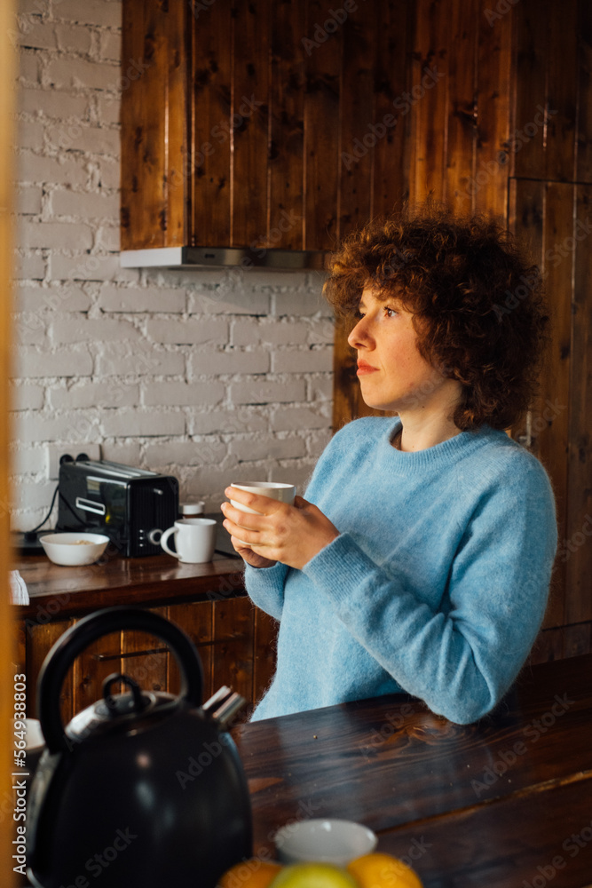 Beautiful Young Woman Drinking Tea in Her Kitchen Stock Photo | Adobe Stock