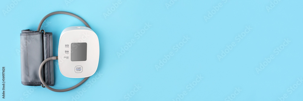 Automatic blood pressure monitor on blue background banner. Medical ...