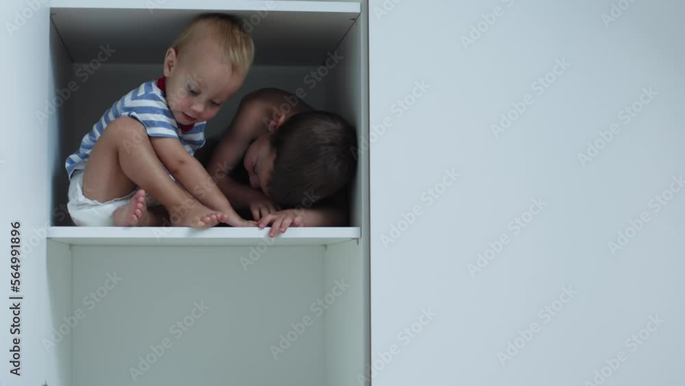 happy children playing hide and seek indoors hiding inside furniture ...