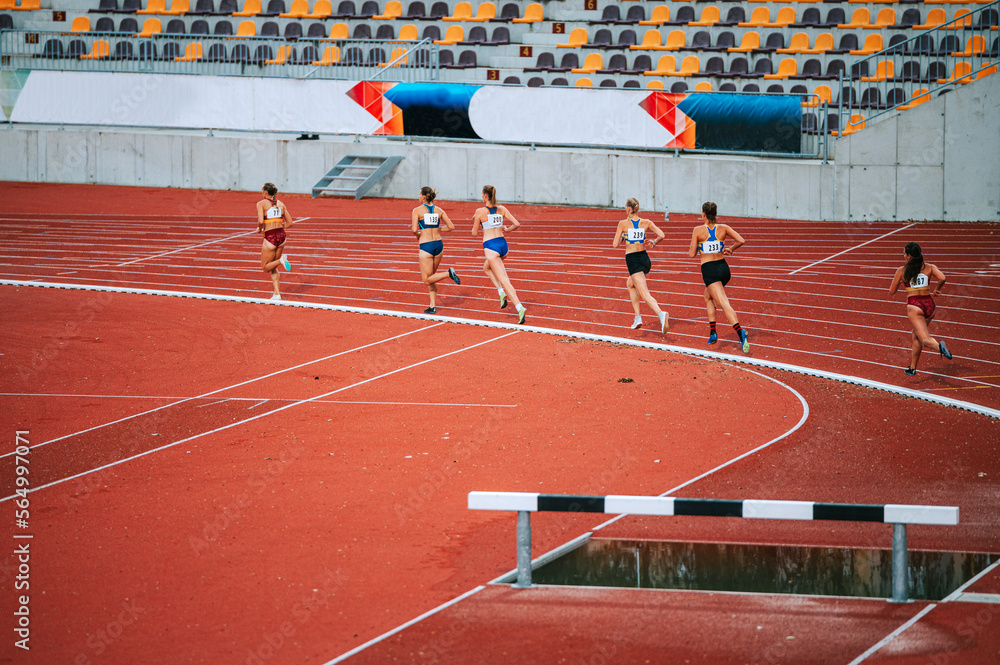 Determined female athletes pushing through long distance race. Great ...