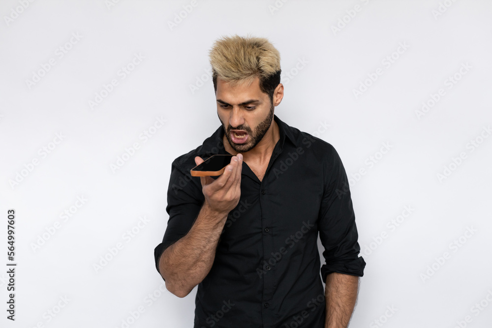 Angry young man talking on mobile phone yelling. Male Caucasian model ...