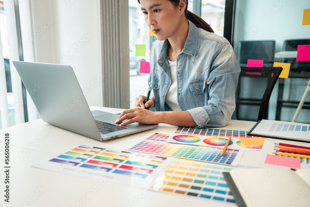 Foto de Young creative graphic designer working on color selection and ...