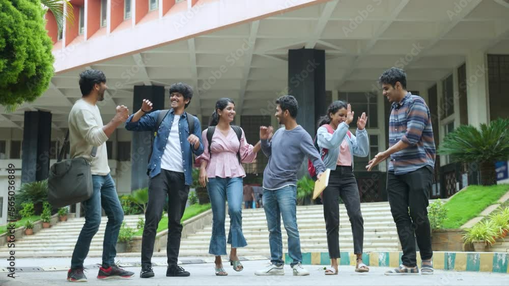 Cheerful group of graduated students jumping at college campus after ...