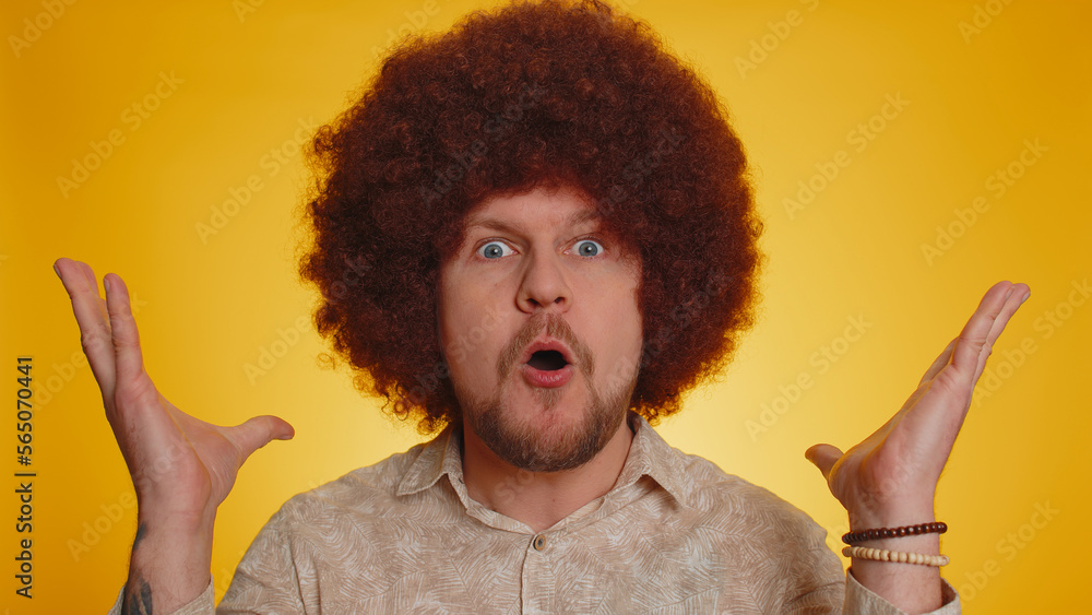 Excited amazed man with lush Afro hairstyle coiffure in touching head ...