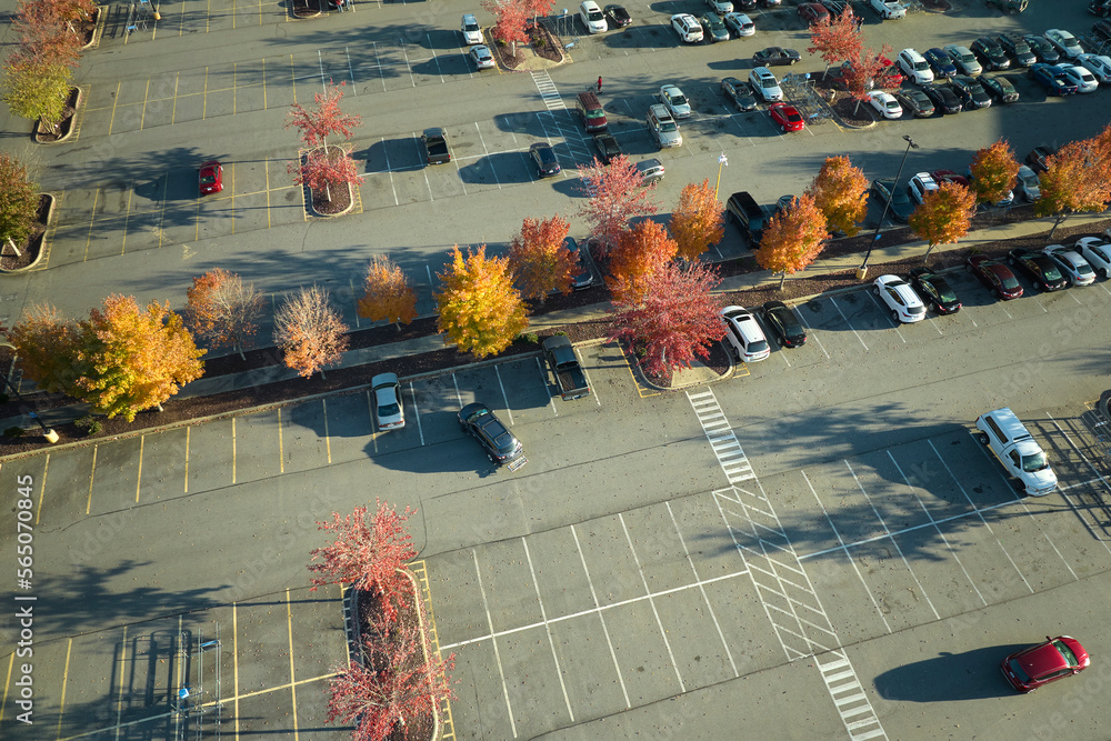 Aerial view of many colorful cars parked on parking lot with lines and ...