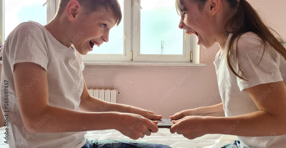 Little boy and girl fight for touchpad computer addiction Stock Photo ...