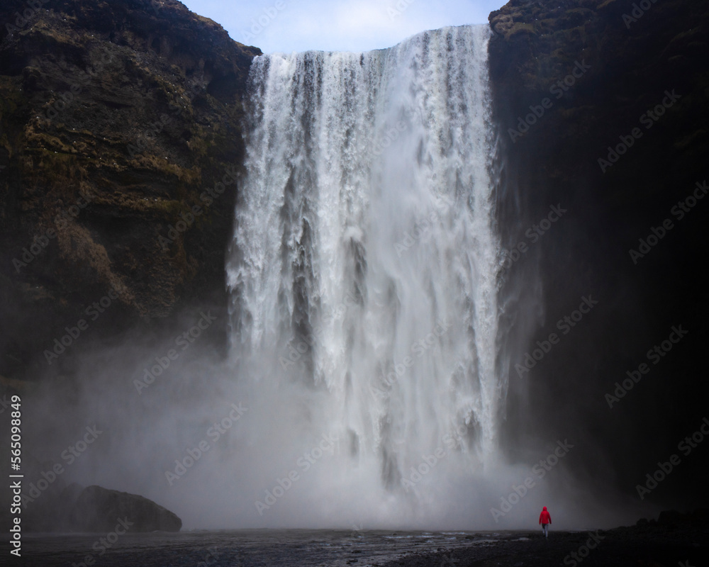 Fearless strong woman faces powerful waterfall; concept of strong and ...