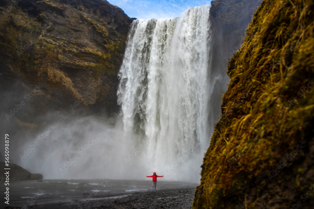Fearless strong woman faces powerful waterfall; concept of strong and ...