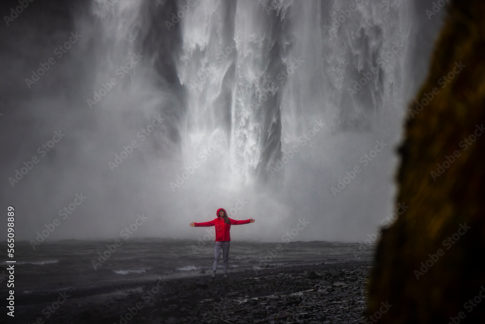 Fearless strong woman faces powerful waterfall; concept of strong and ...